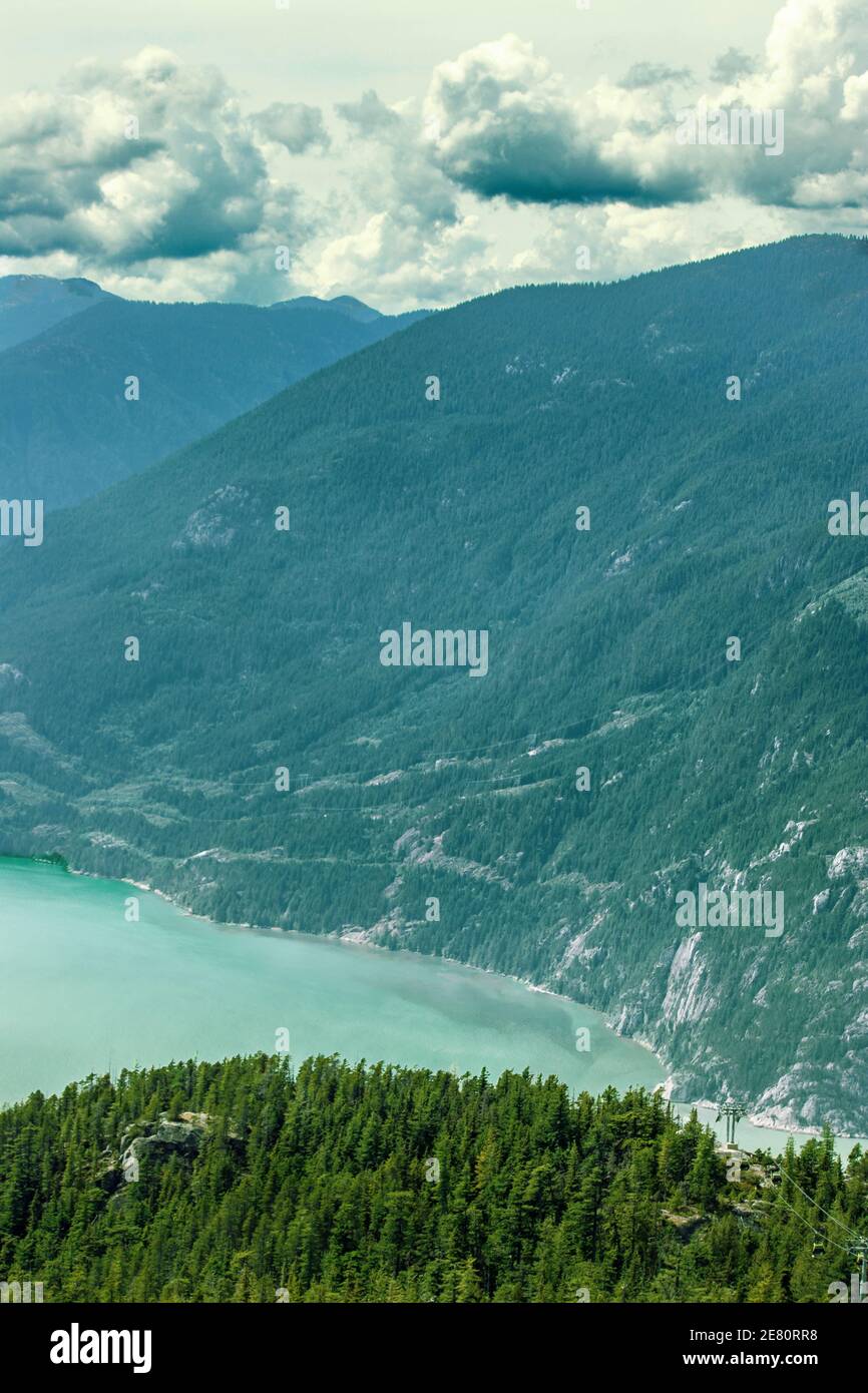 The teal ocean meets the mountains, Squamish, BC, Canada. Squamish is a ...