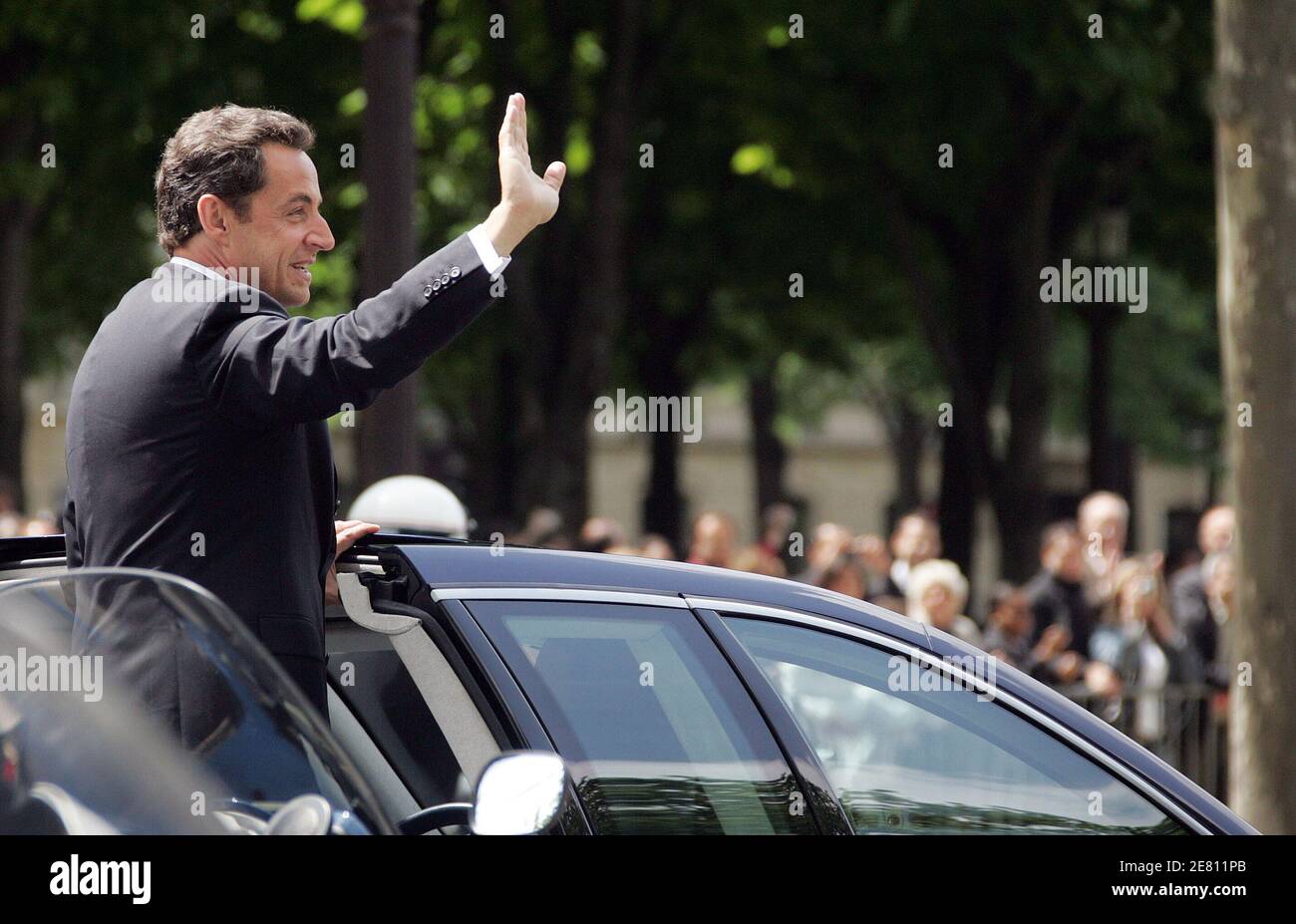 New French President Nicolas Sarkozy waves as he is driven up the ...