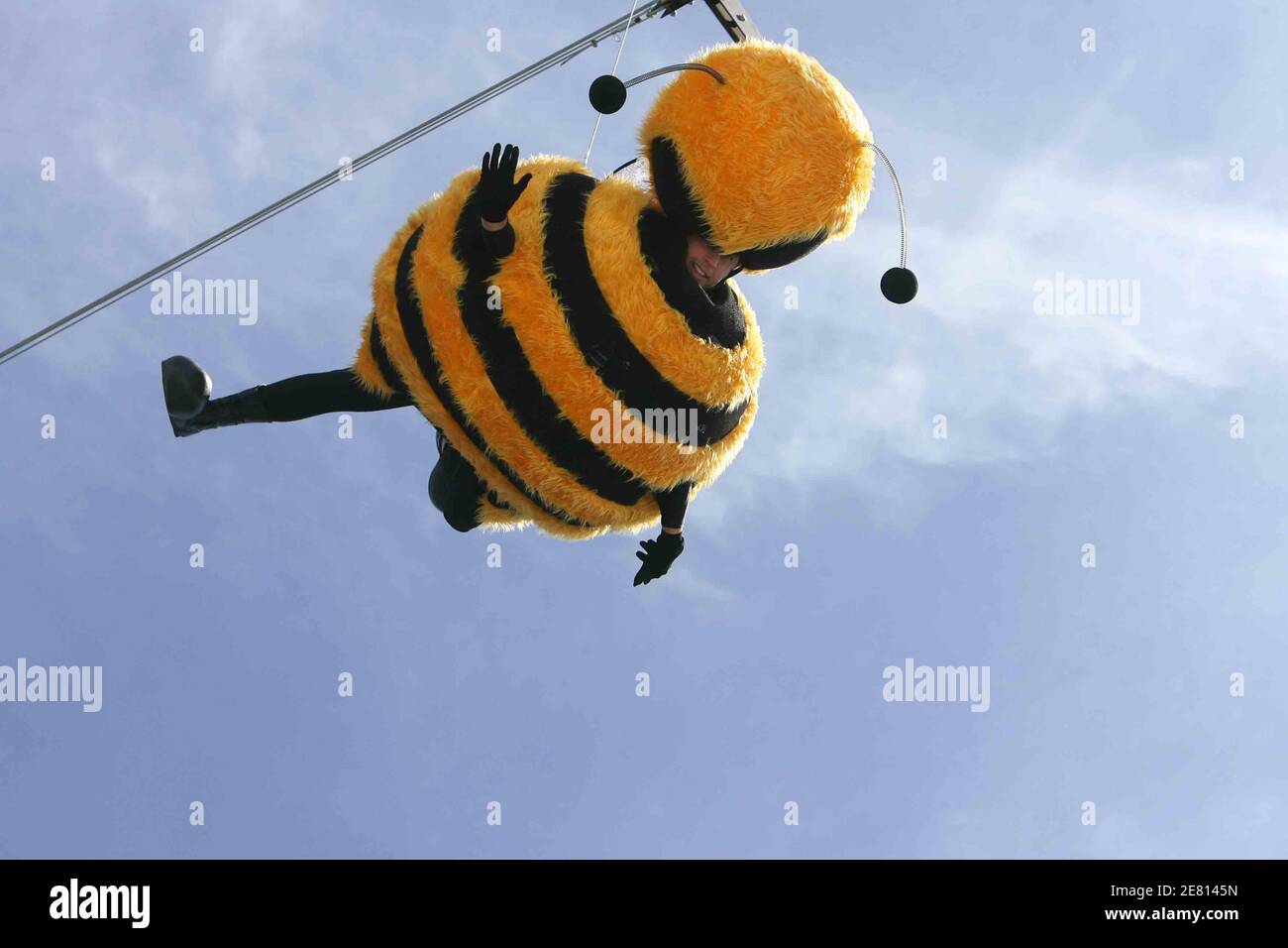 US actor Jerry Seinfeld, dressed as a giant bug, flies from the rook of ...