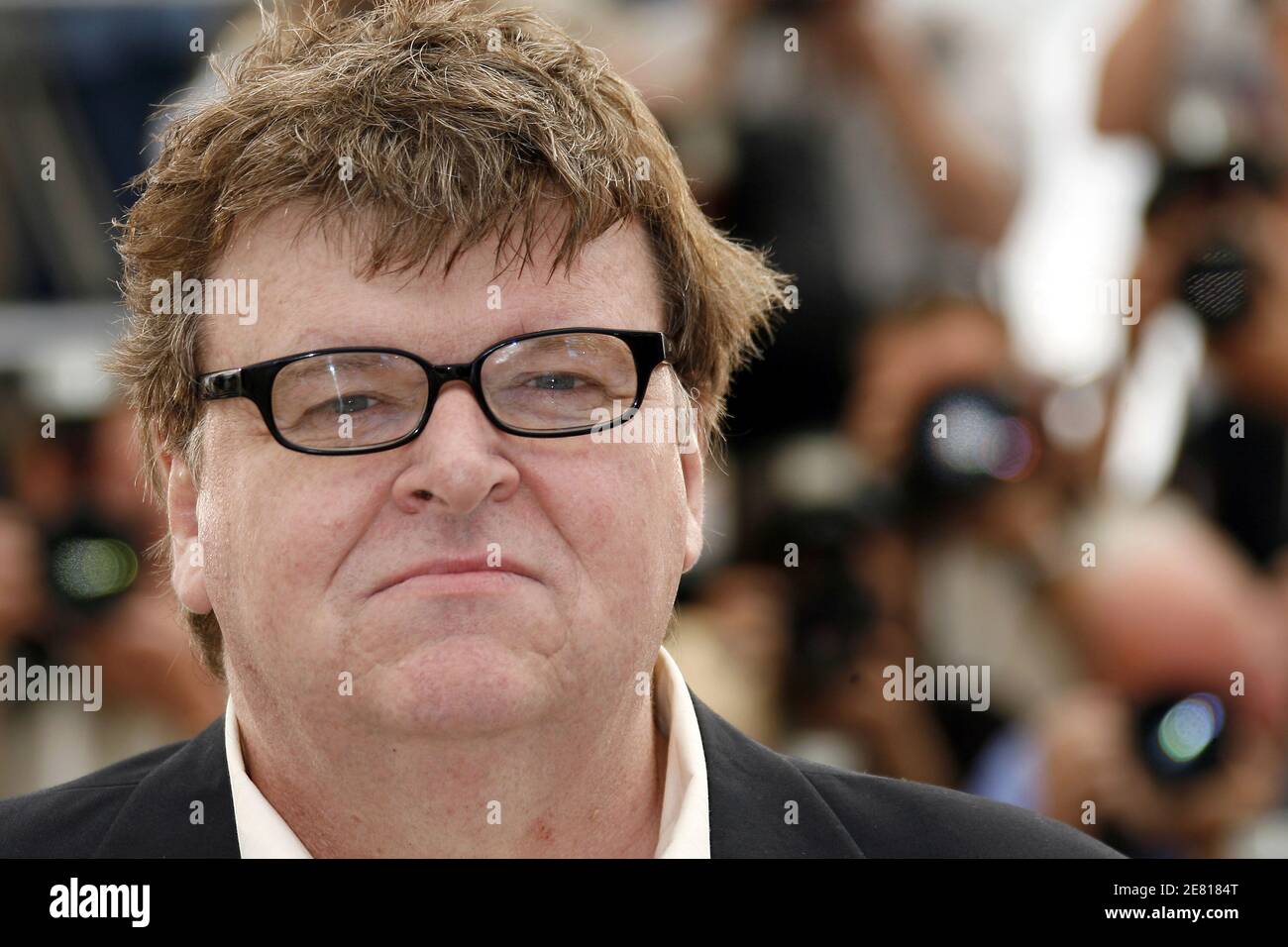 Michael Moore poses for the media during a photocall for 'SICKO' during ...