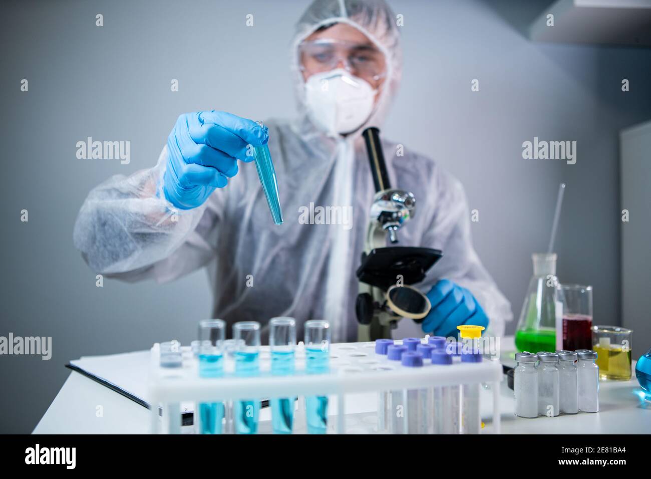 Close-up of scientists hand in blue latex gloves examines samples ...