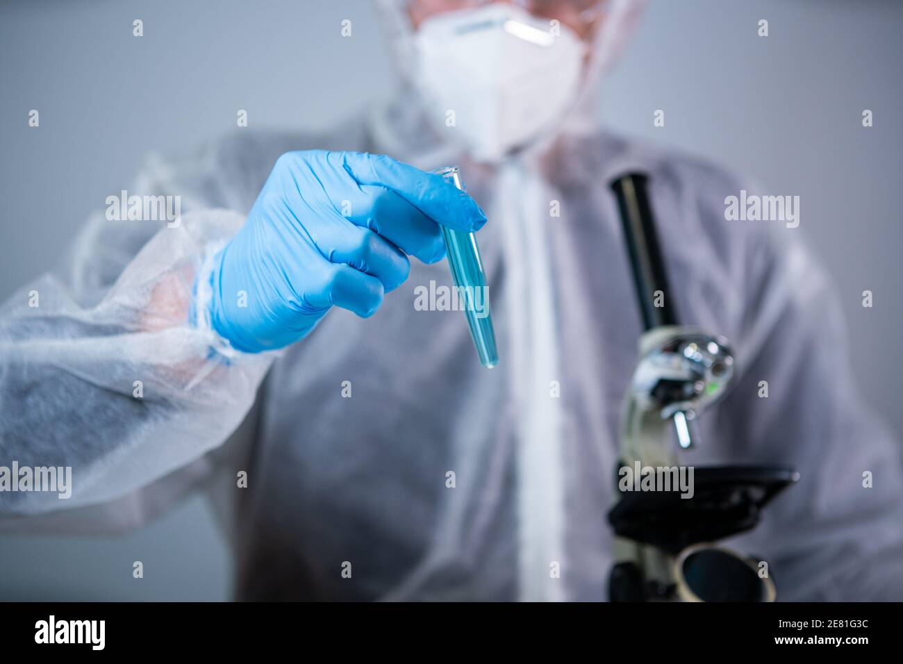 Biochemistry laboratory research, chemist in protective suit analyzing ...