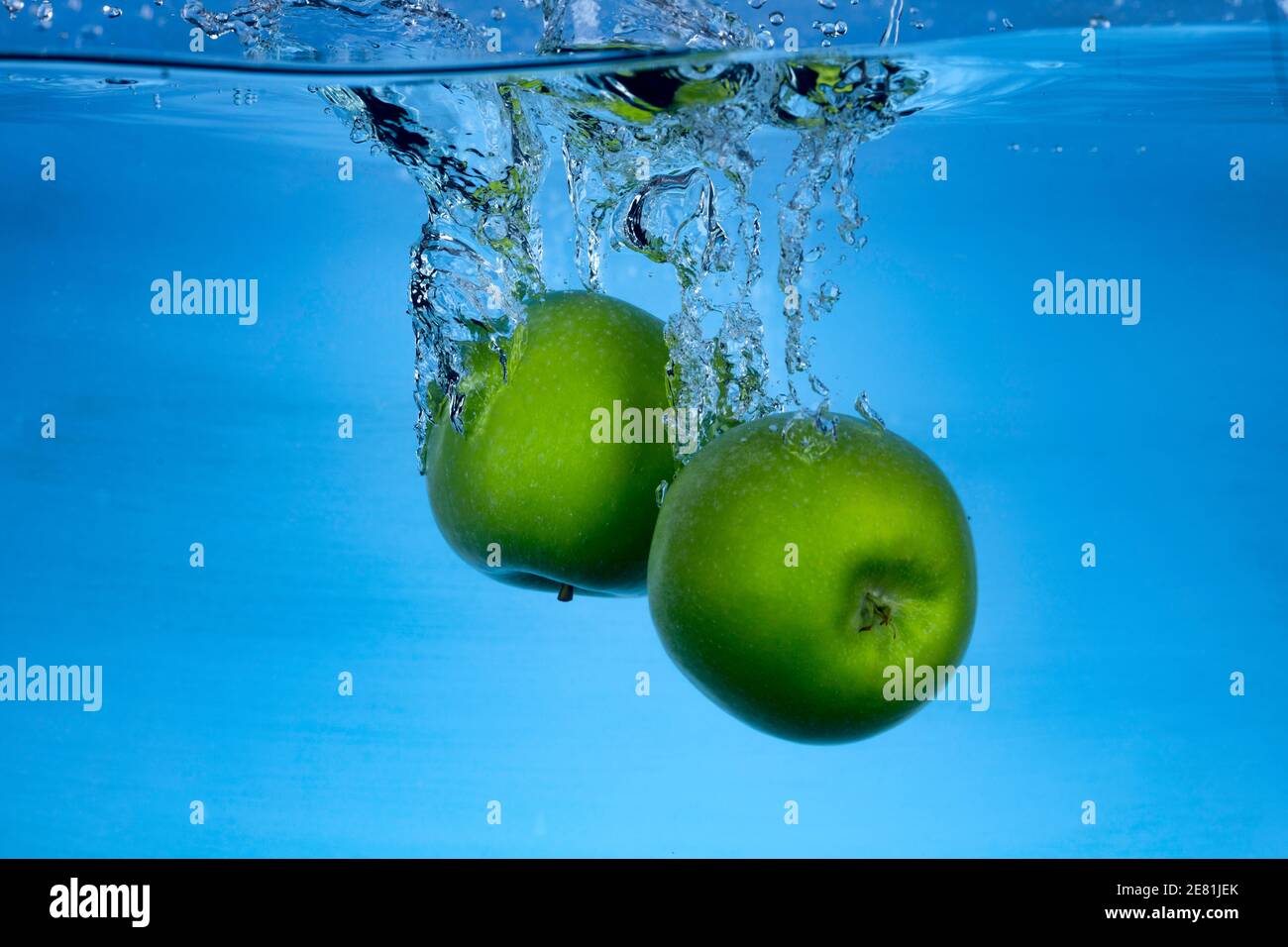 Freeze motion photo of two apples dropped into water to be washed Stock ...