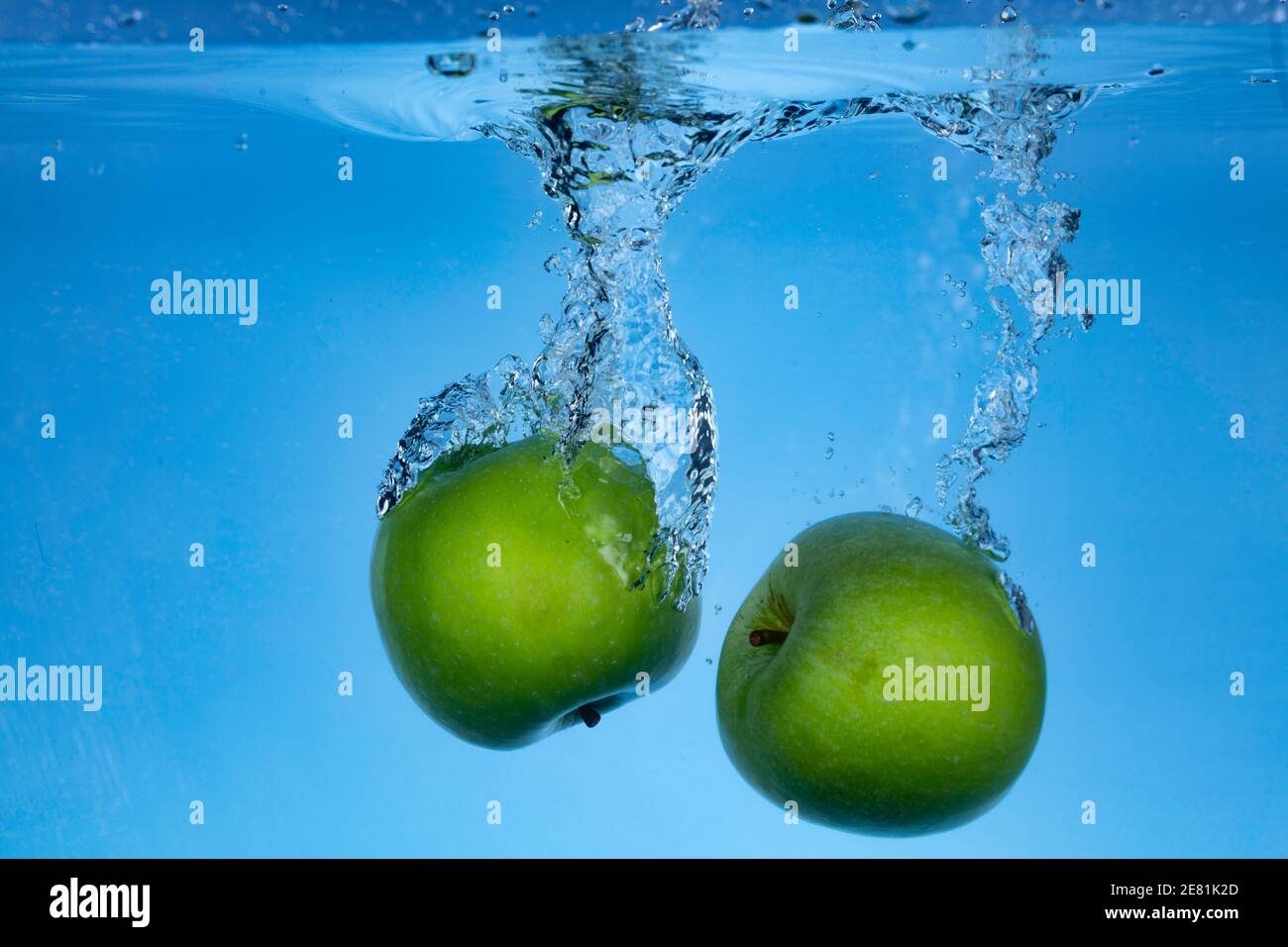 Freeze motion photo of two apples dropped into water to be washed Stock ...