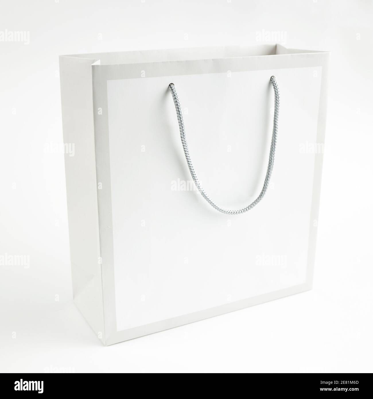 light gray paper bag mockup for design on a gray background. space for ...