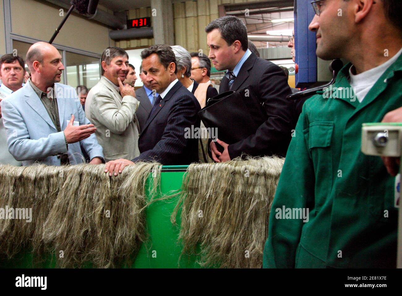 French President Nicolas Sarkozy meets with workers as he visits the ...