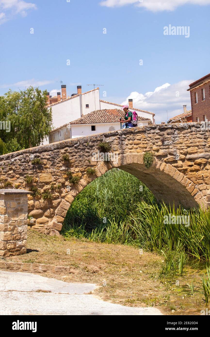Man walking over the medieval bridge forming part of the pilgrim route ...