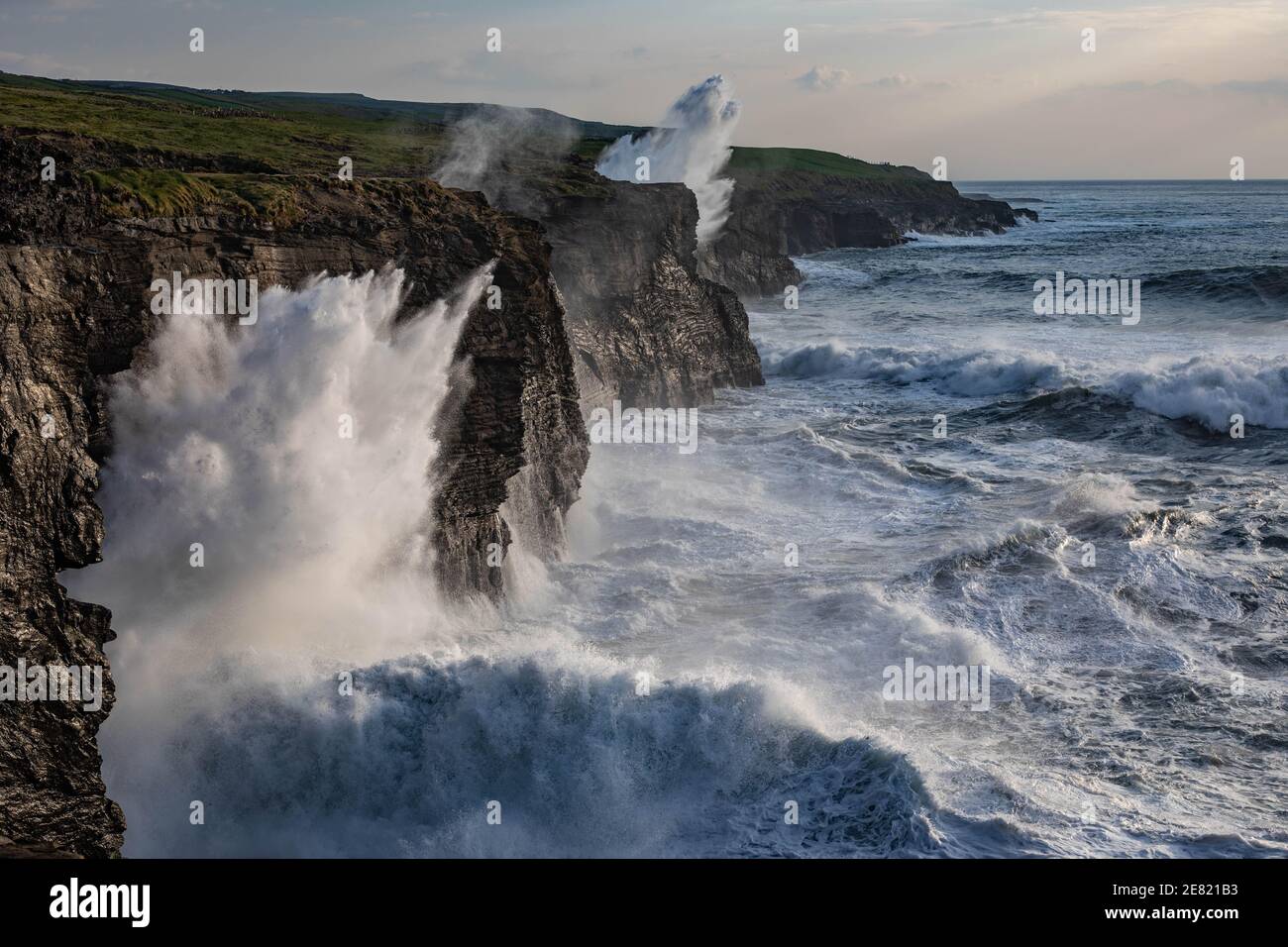 Rough ocean with big waves crashing against cliffs in Co. Clare ...