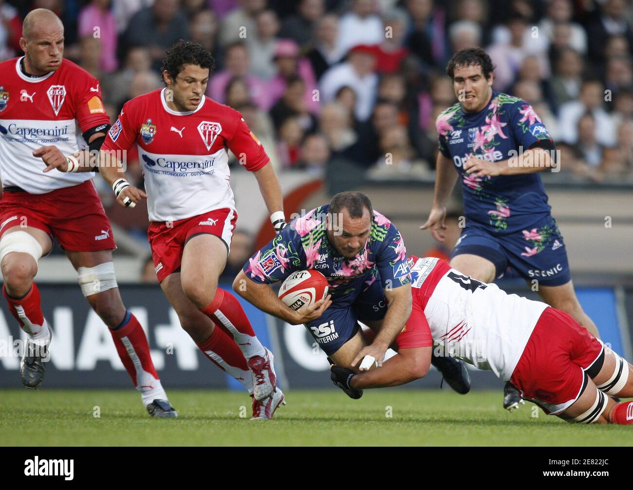 Stade Francais' Rodrigo Roncero takled by Biarritz' David Couzinet ...