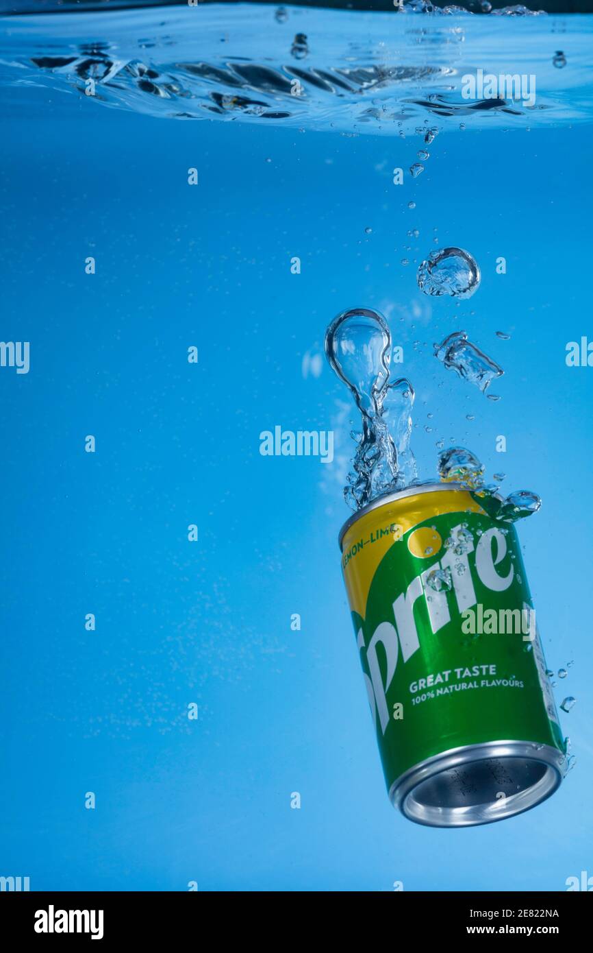 Freeze motion photo of a Sprite can dropped into water Stock Photo - Alamy