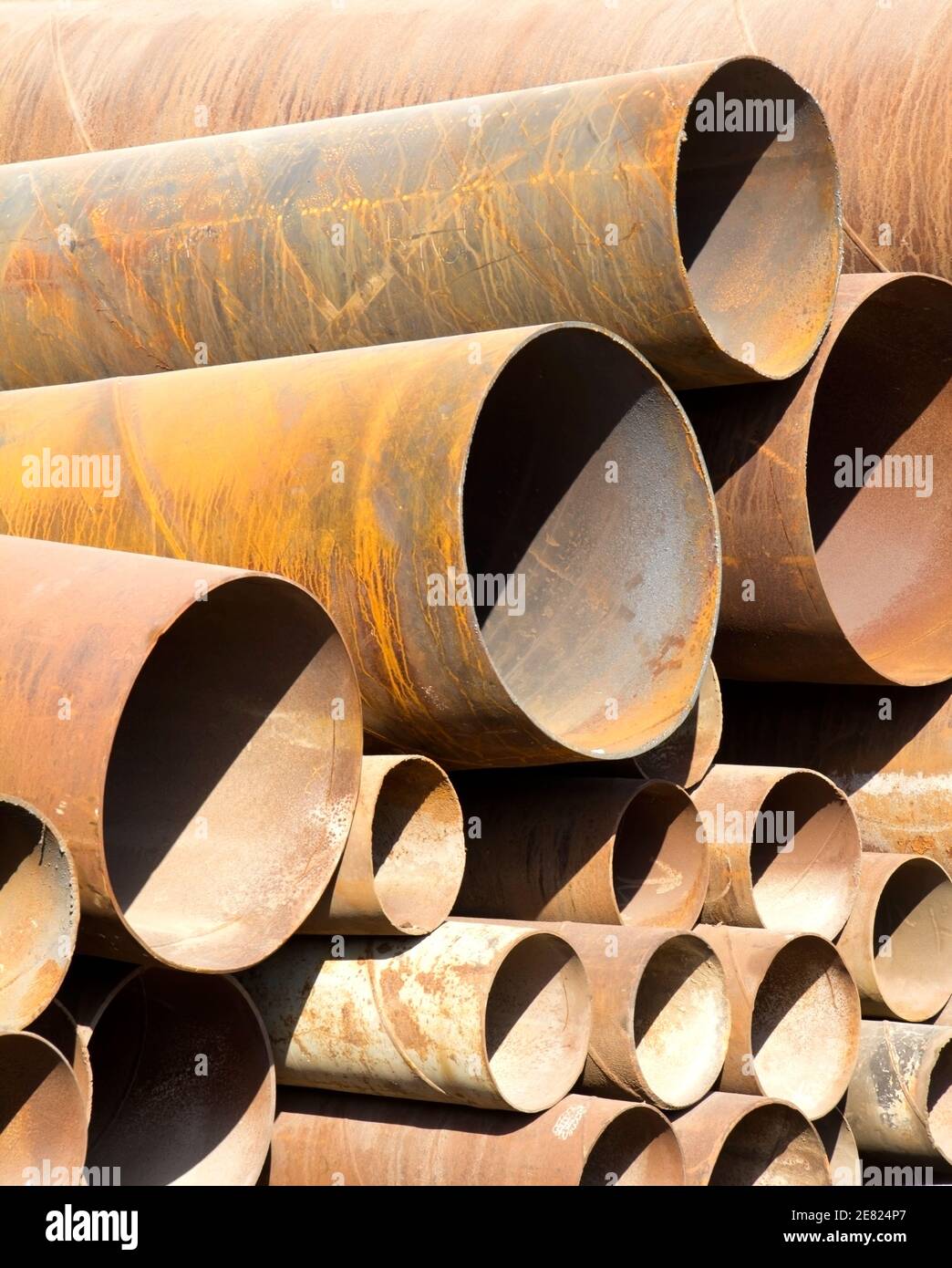 Rusty old pipes stacked up Stock Photo - Alamy