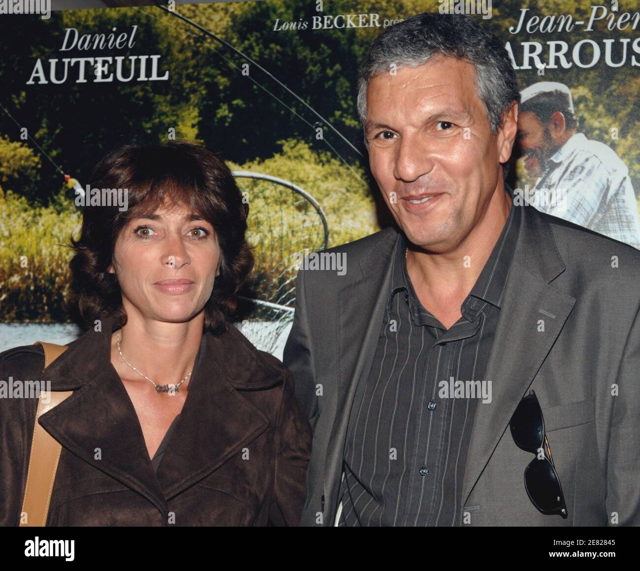 TV anchor Rachid Arhab and his wife pose for pictures as they arrive to ...