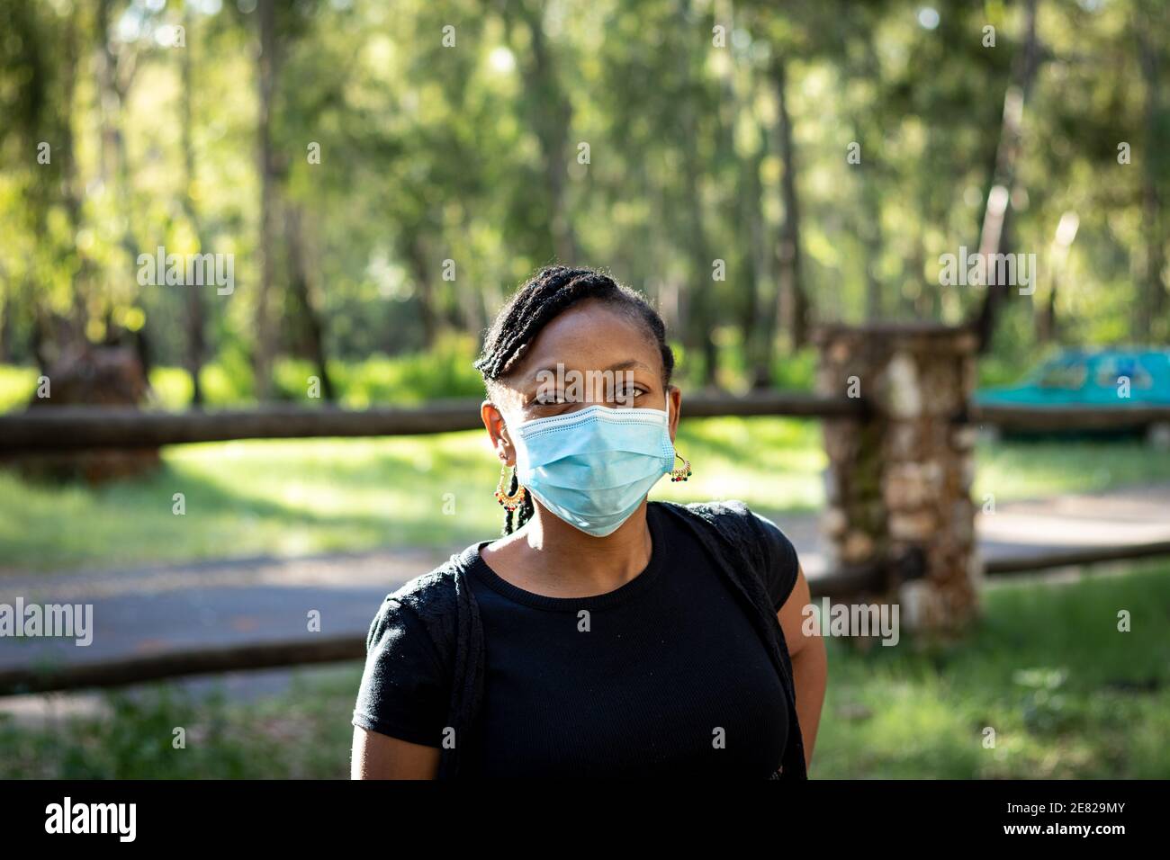 Woman wearing black facemask hi-res stock photography and images - Alamy