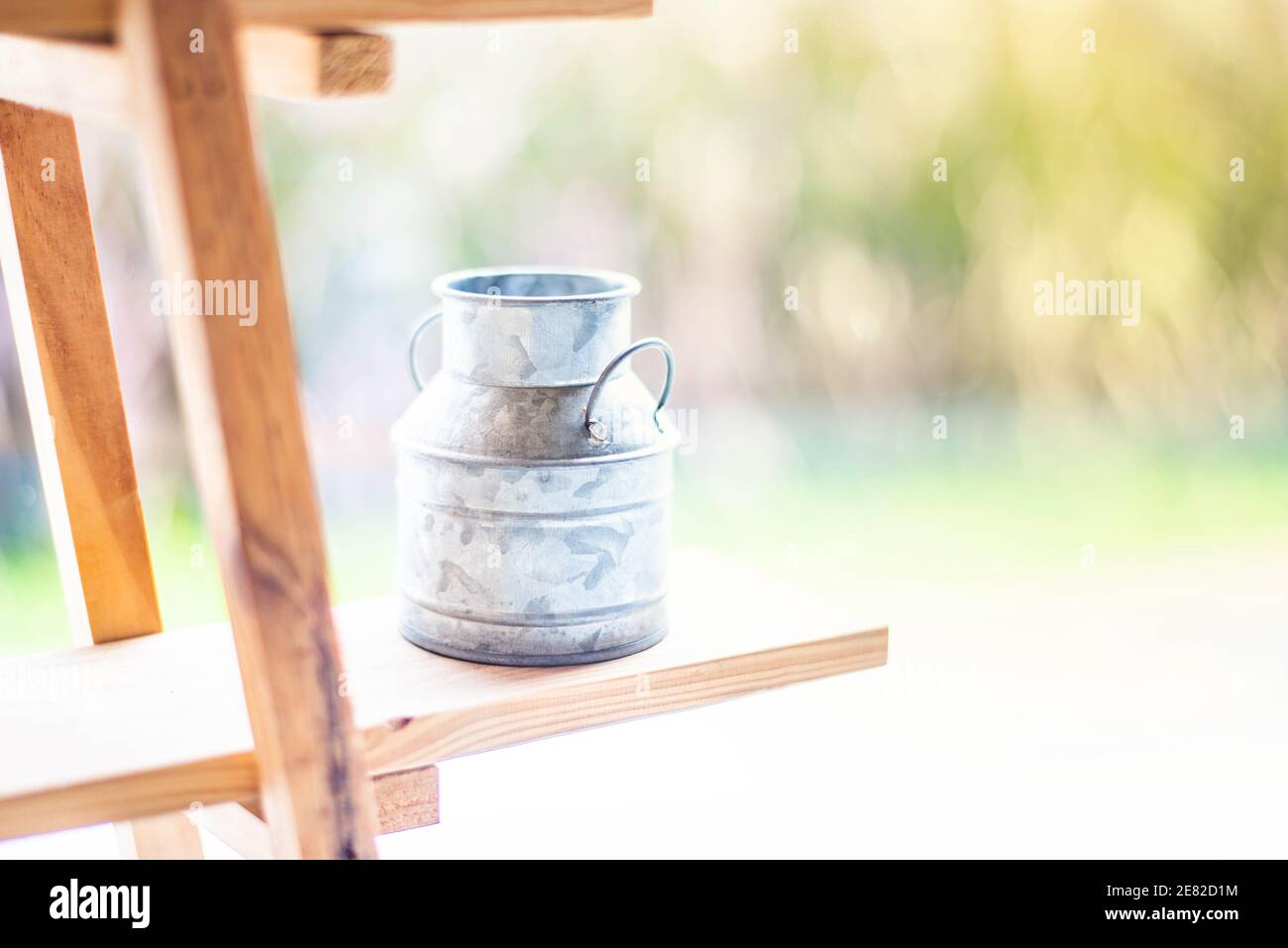 Milk bucket on wood floor Stock Photo - Alamy