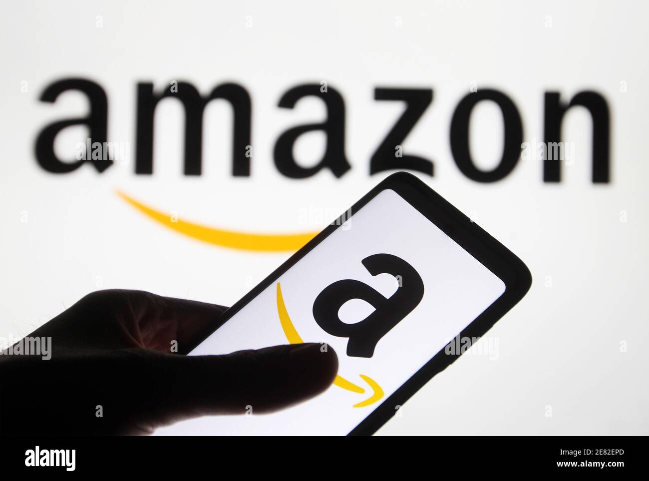 In this photo illustration an Amazon, logo seen displayed on a mobile ...