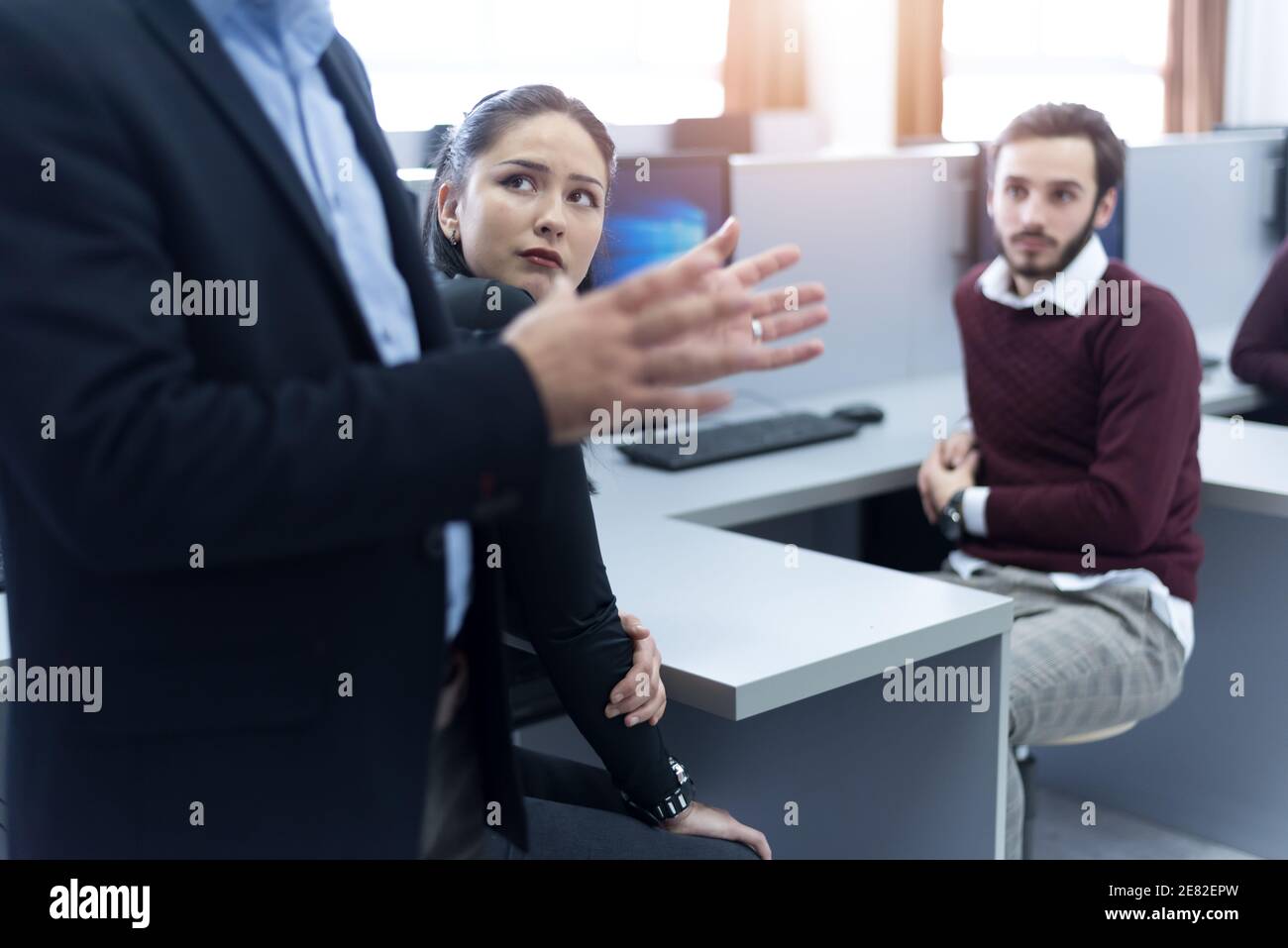 Teacher assisting college student in a computer lab. Technology and ...