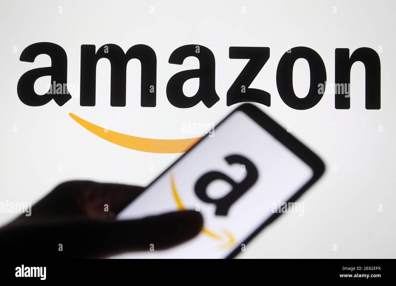 In this photo illustration an Amazon, logo seen displayed on a mobile ...