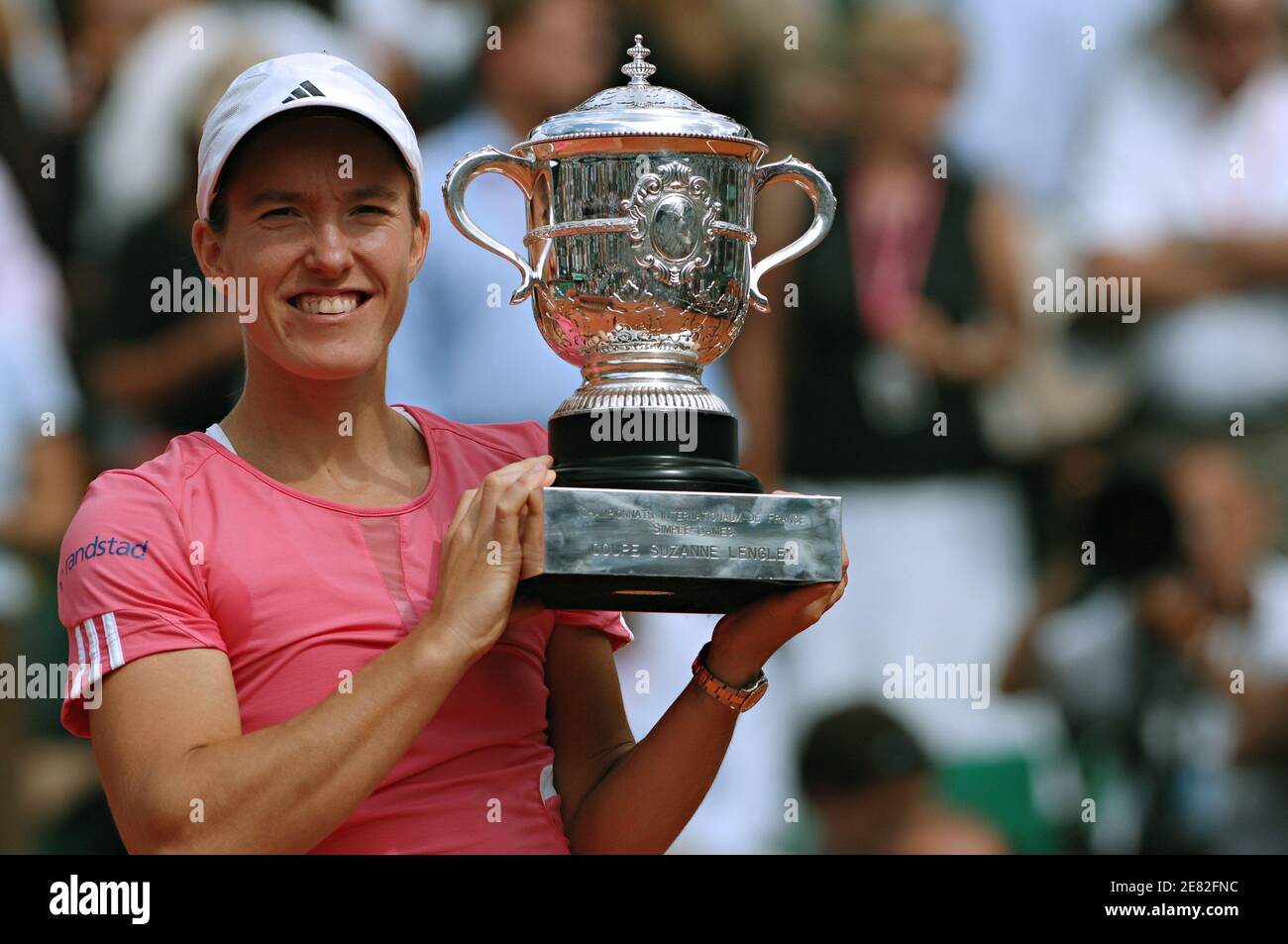 Belgium's Justine Henin holds the trophy after beating Serbia's Ana ...