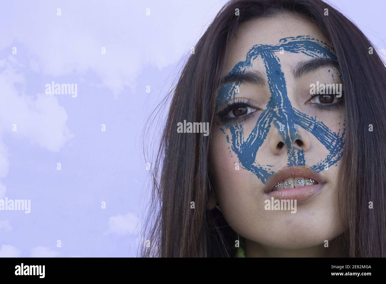Peace symbol painted on a face of a young female Stock Photo - Alamy