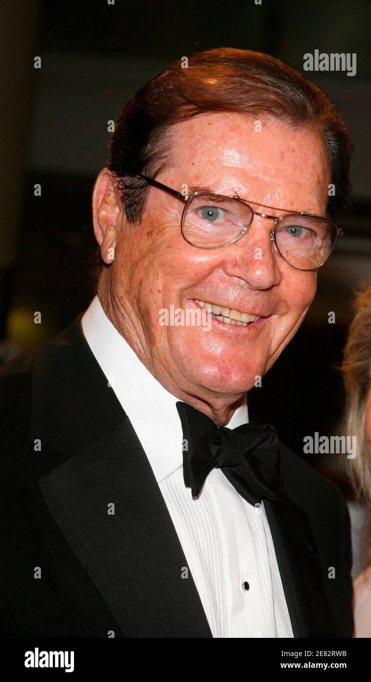 Sir Roger Moore poses for pictures during the closing ceremony of the ...