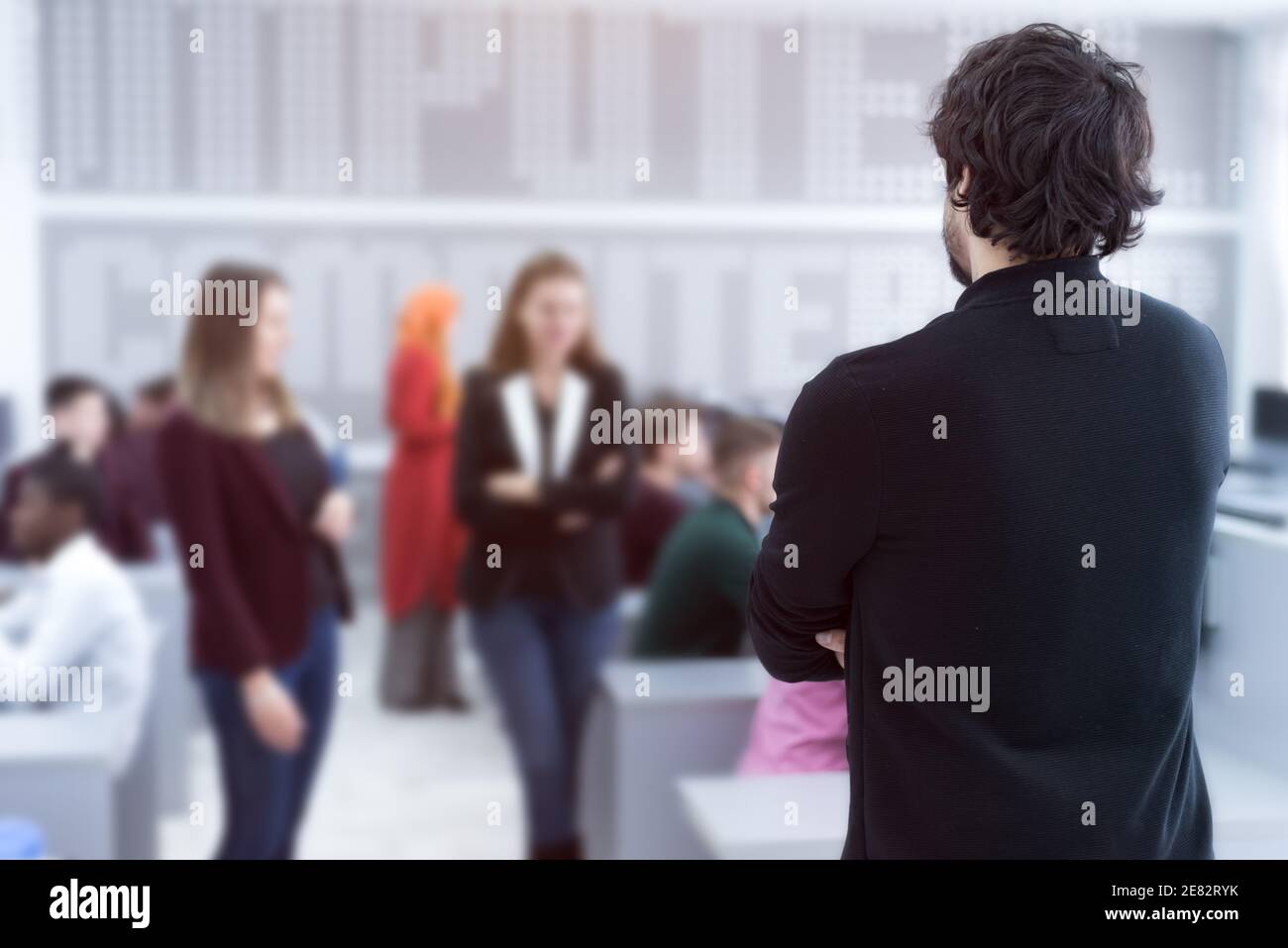 Teacher assisting college student in a computer lab. Technology and ...