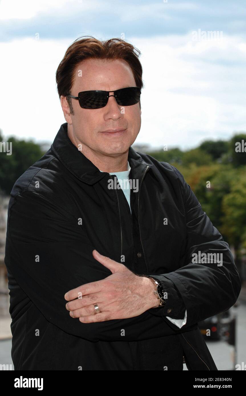 American actor John Travolta poses for pictures, as part of the ...