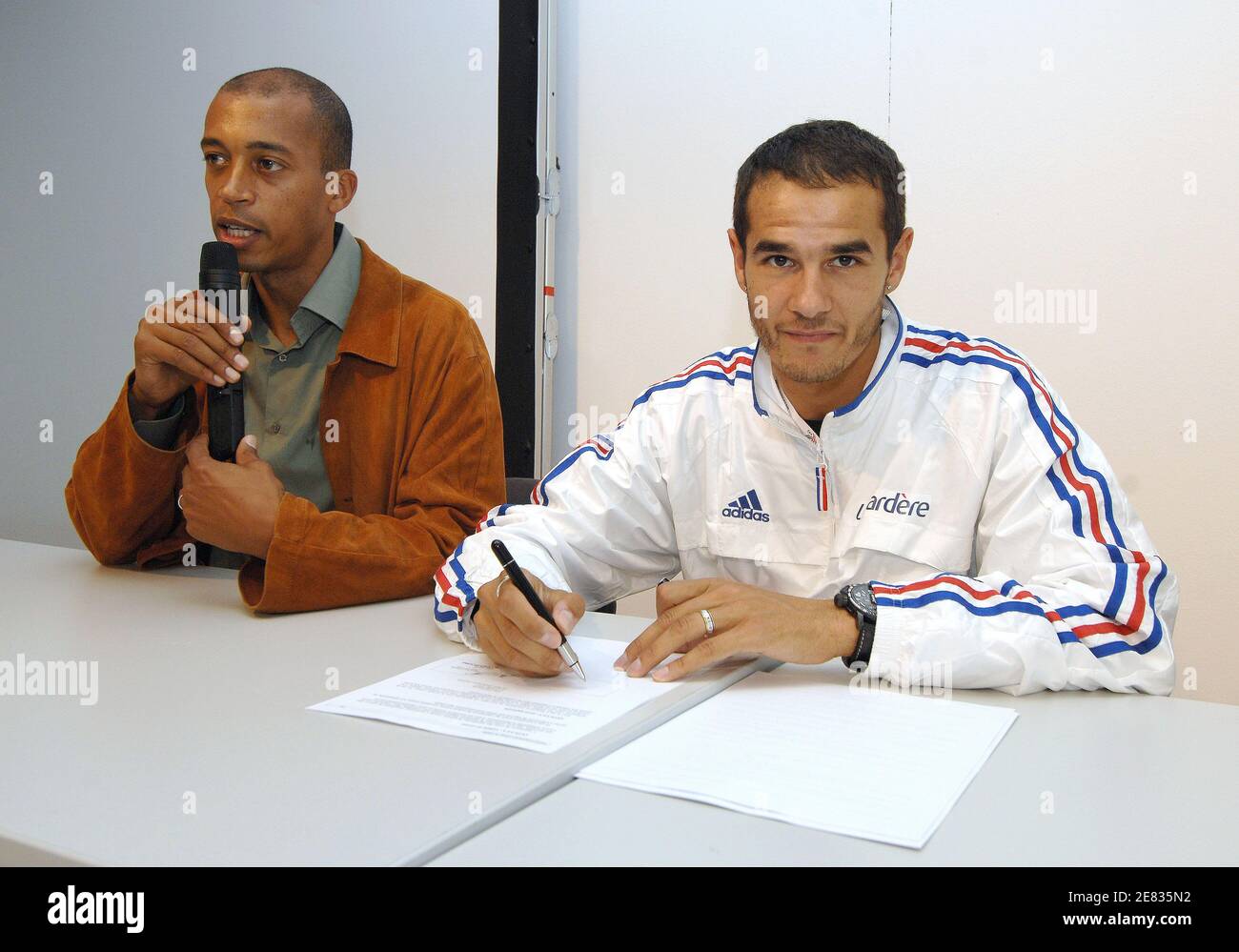 (R-L) French athlet Mehdi Baala signs a professional contrat with ...