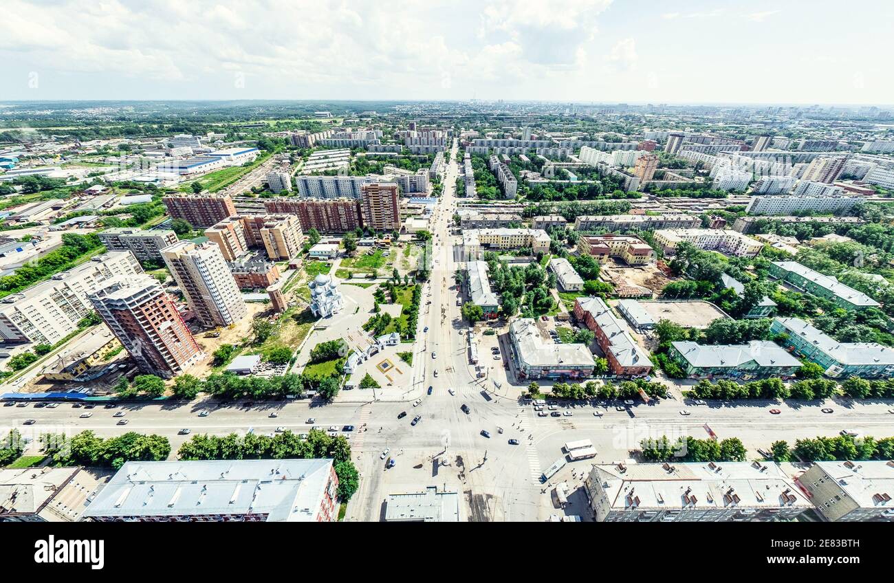 Aerial city view with crossroads and roads, houses, buildings, parks ...