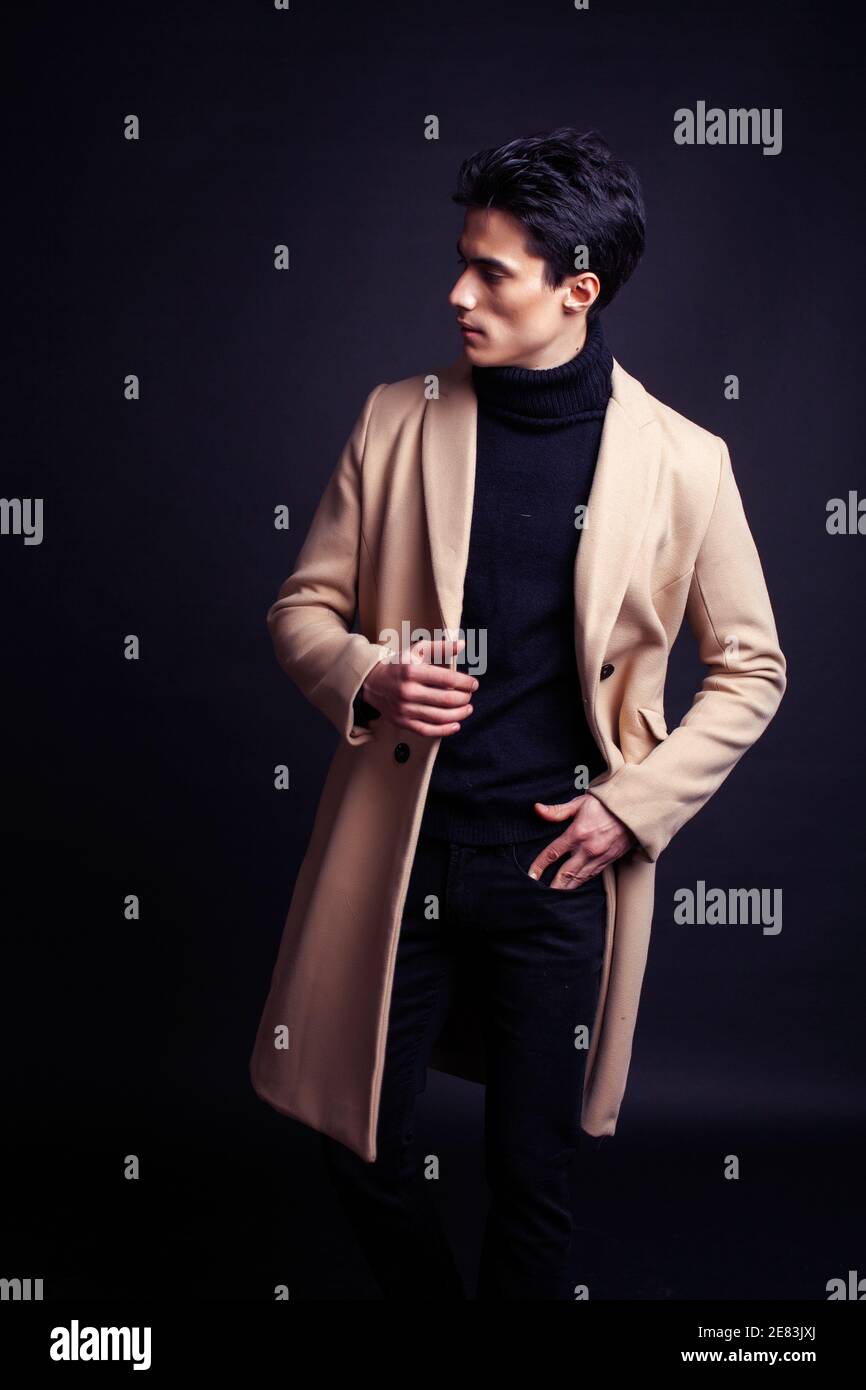 handsome asian fashion looking man posing in studio on black background ...