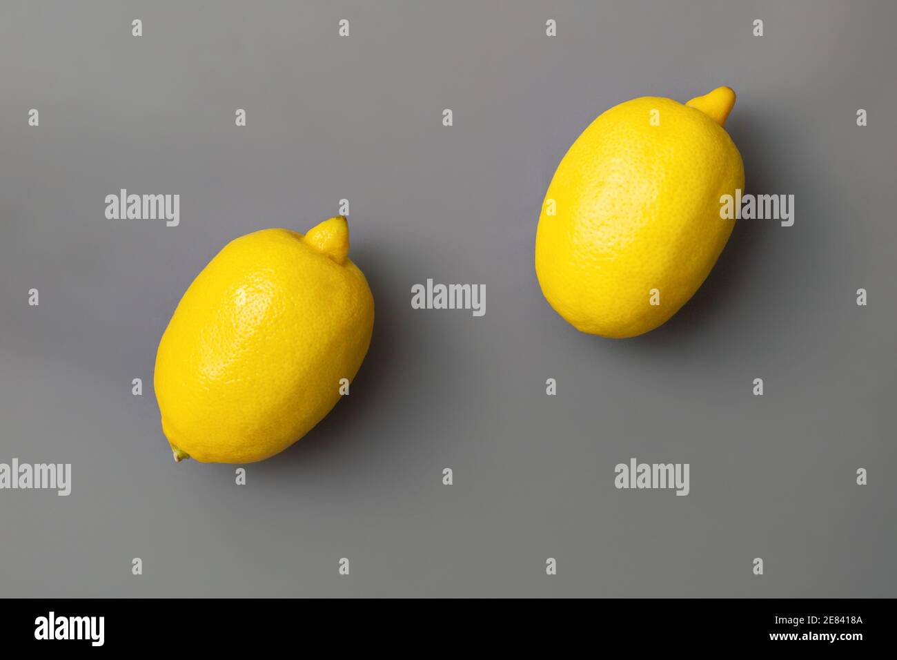 Yellow lemons on gray background. Colors of the Year 2021 Pantone ...