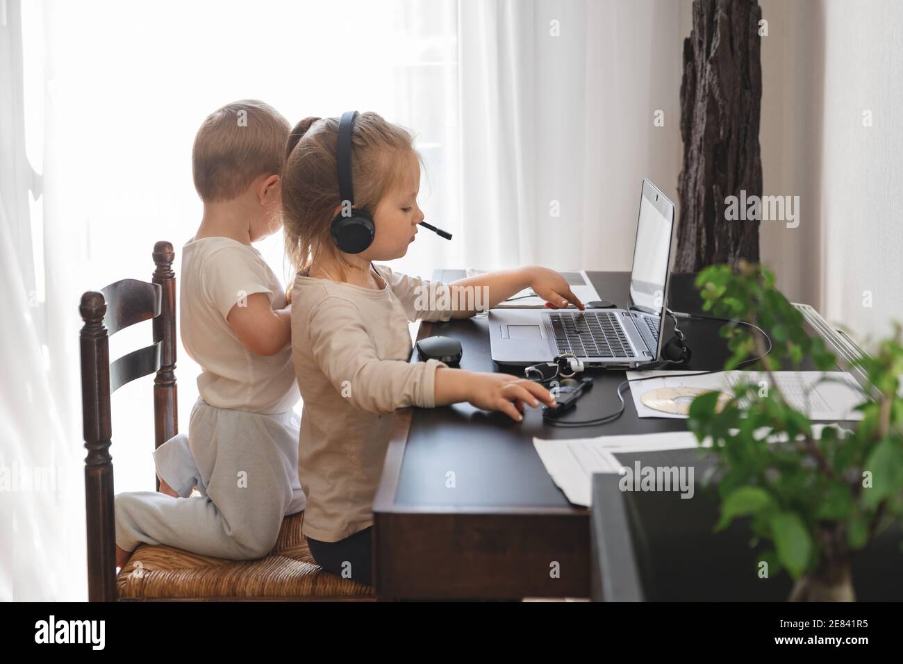 Little children play with computer of parents Stock Photo - Alamy