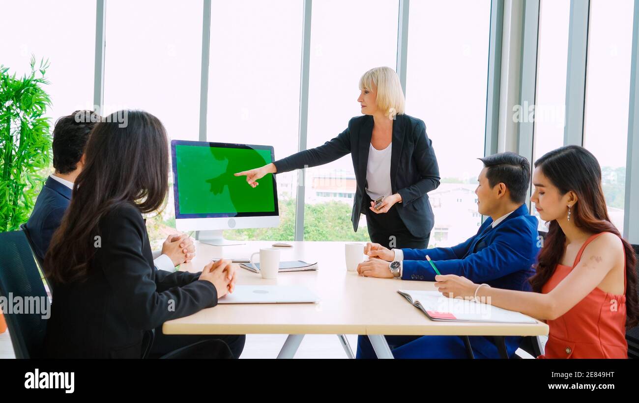 Business People In The Conference Room With Green Screen Chroma Key Tv Or Computer On The Office