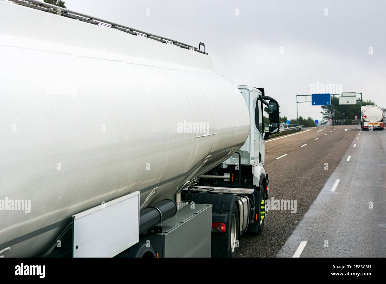 Two fuel tanker trucks driving on the highway Stock Photo - Alamy