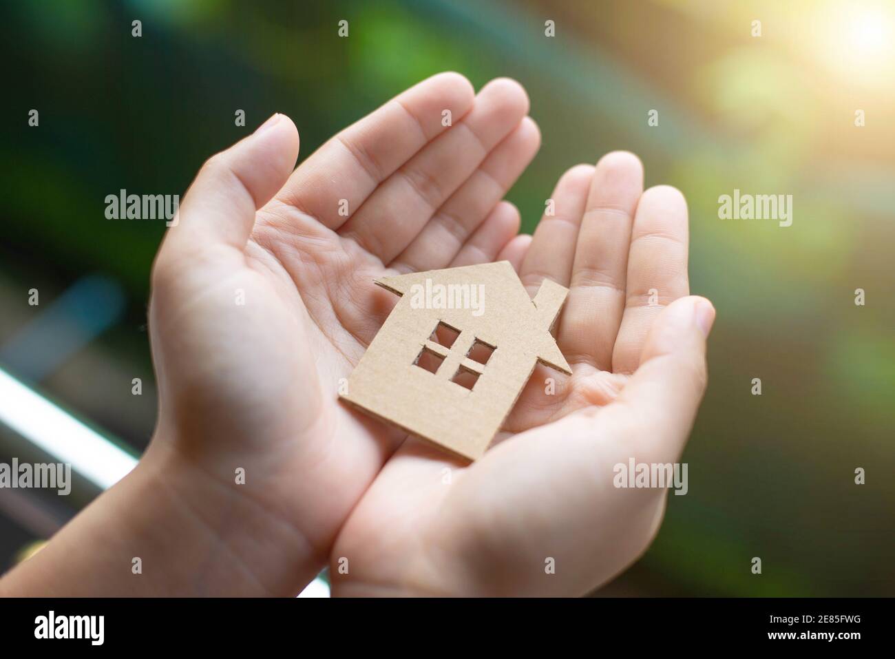 Hands protecting house hi-res stock photography and images - Alamy