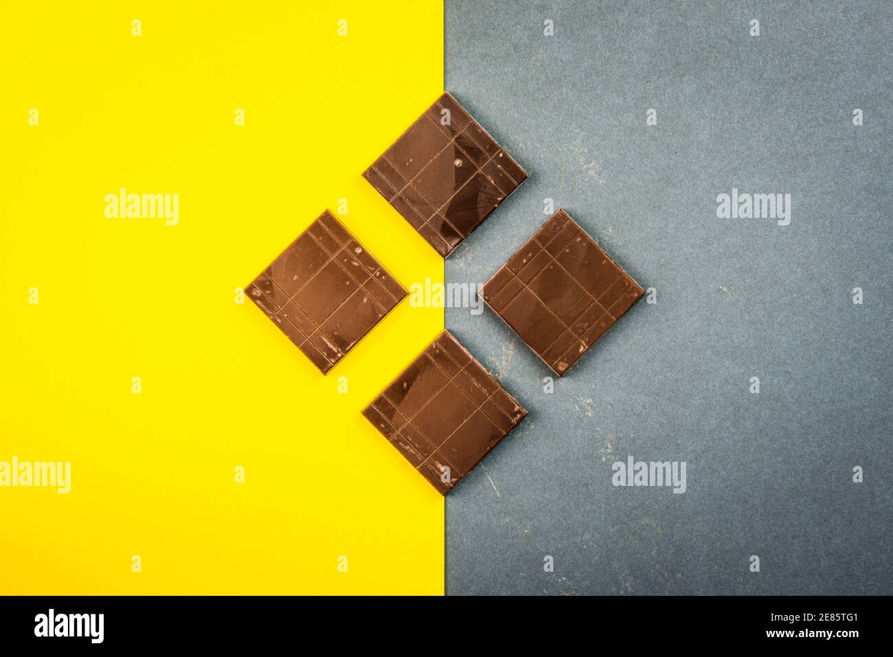 chocolate bars create geometric shapes on a yellow and gray background ...
