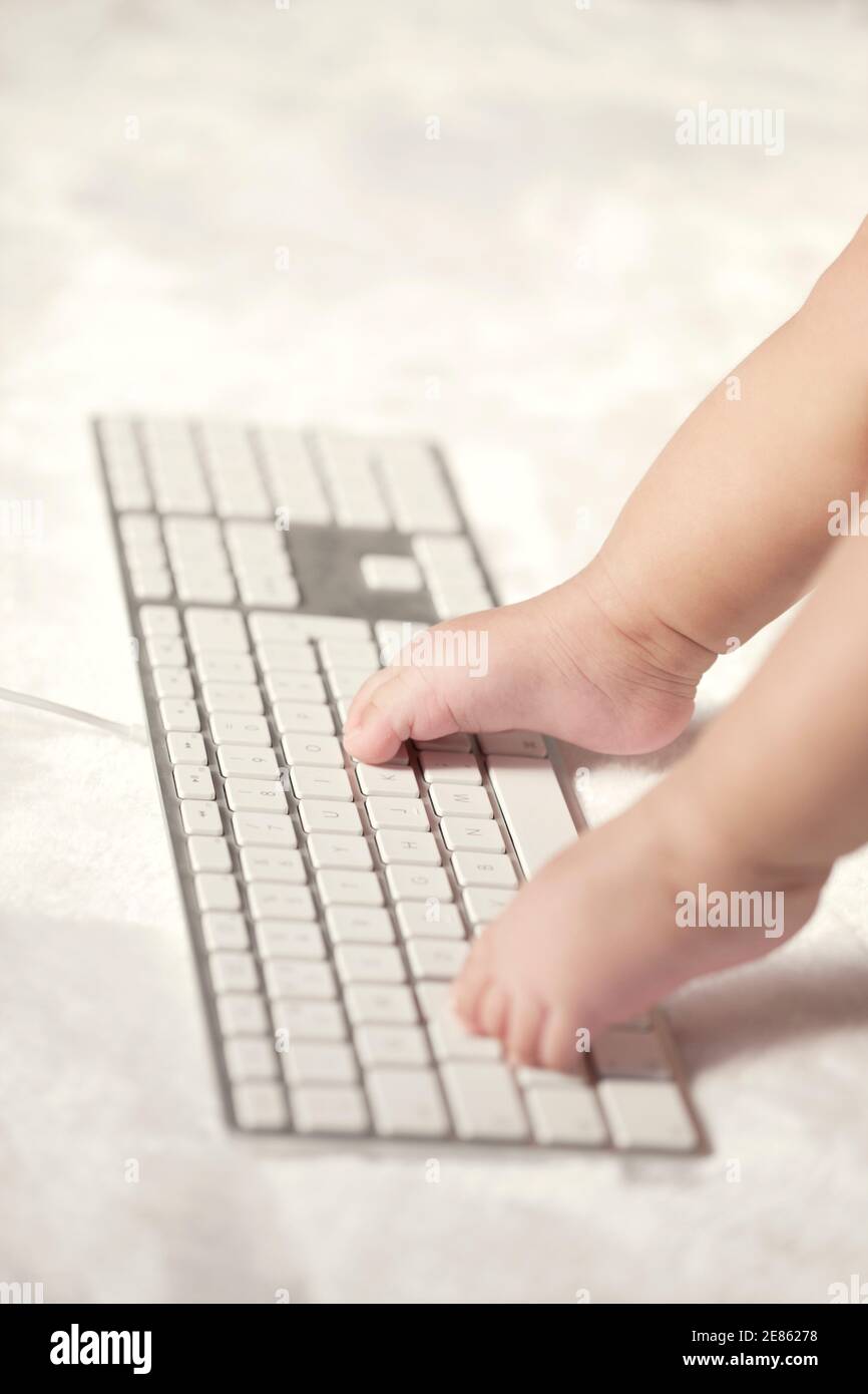 Baby touching computer keyboard high quality photo Stock Photo - Alamy