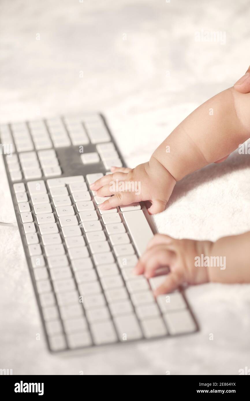 Baby touching laptop keyboard hi-res stock photography and images - Alamy