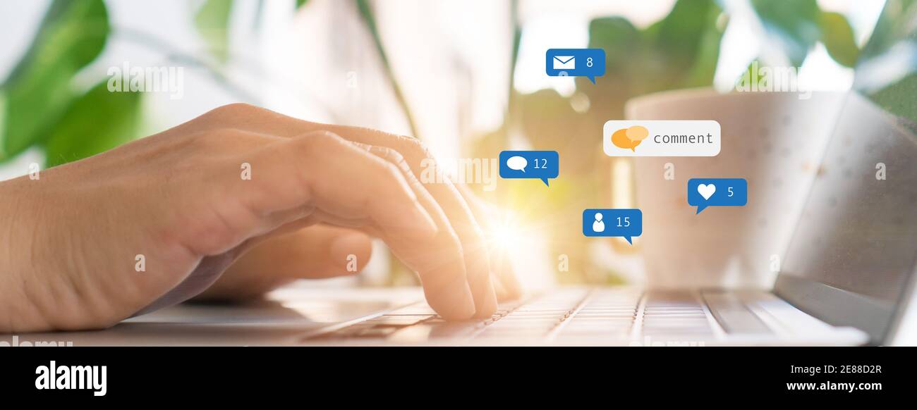Hand typing keyboard with laptop computer with social media and ...
