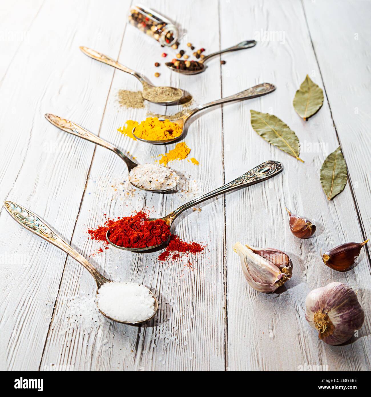 Various spices in vintage spoons, selective focus, close-up. Salt ...