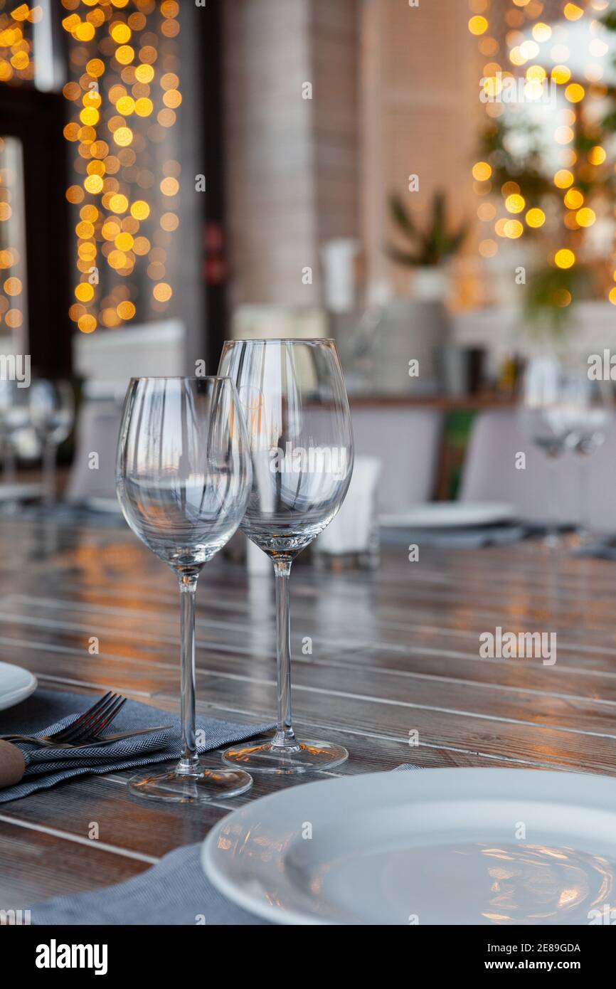 Modern veranda restaurant interior, banquet setting, glasses, plates ...