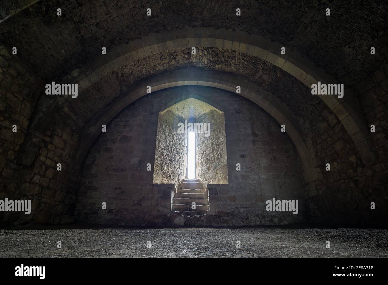 Light shining through a slit window in a cellar in Helmsley Castle ...