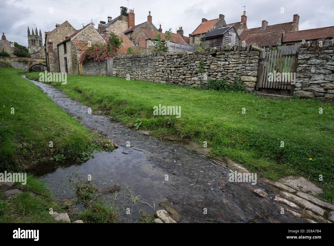 Traditional North Yorkshire houses and small stream along Castlegate ...