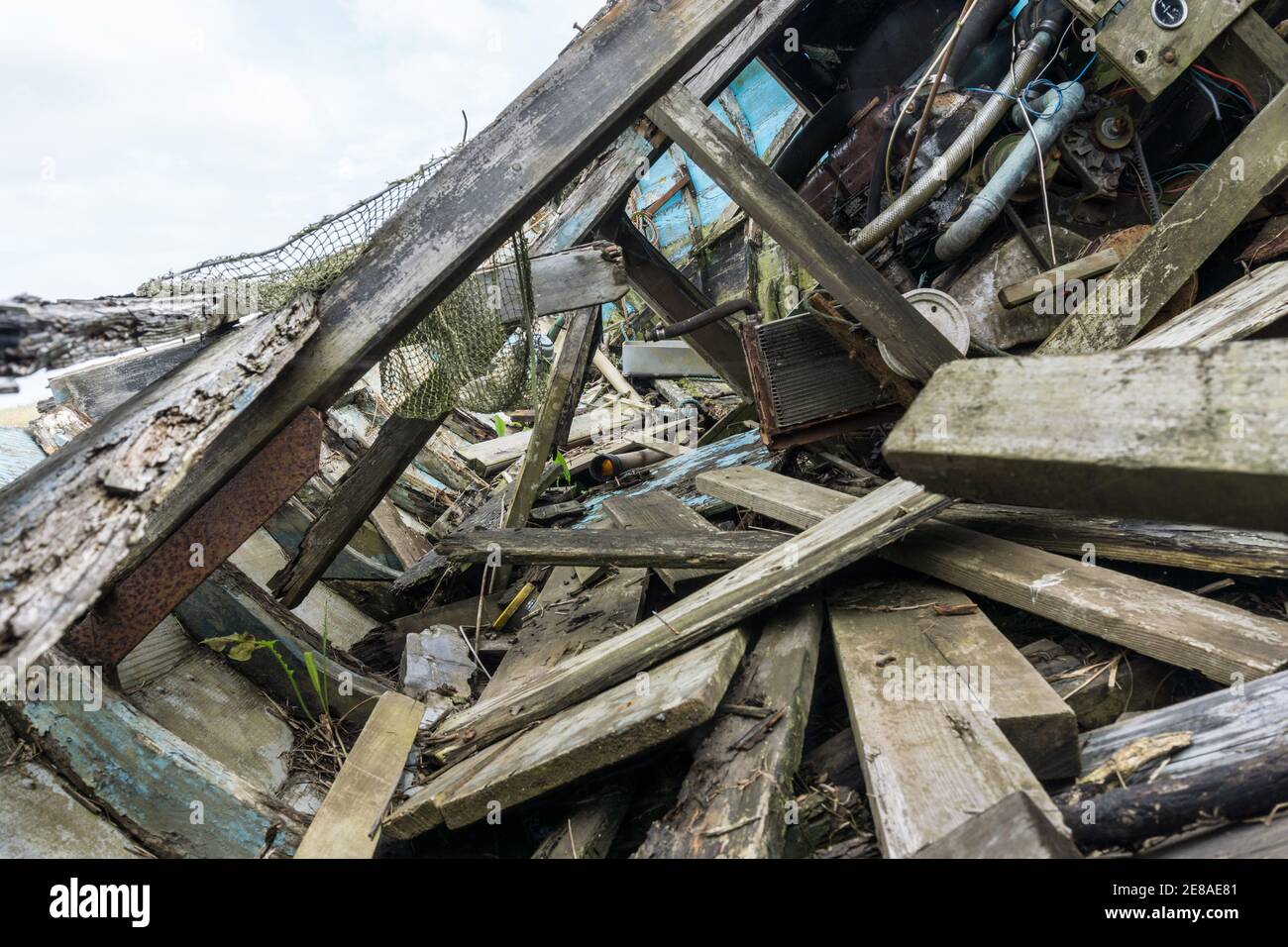 Rotten interior of an abandoned wooden Montagu whaler boat on the sand ...