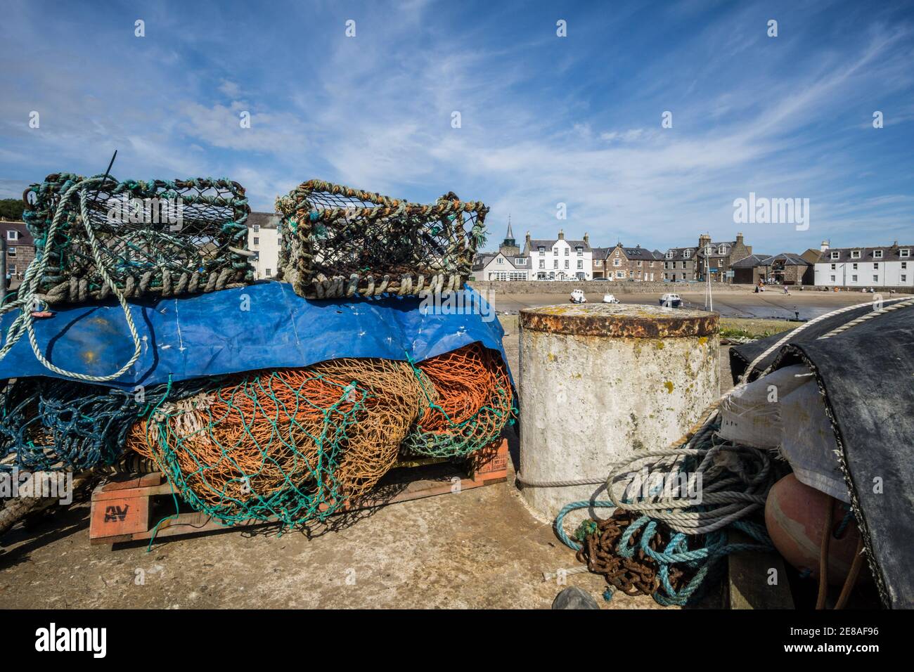 Fishing nets, ropes and baskets on a quay in Stonehaven harbour, a town ...