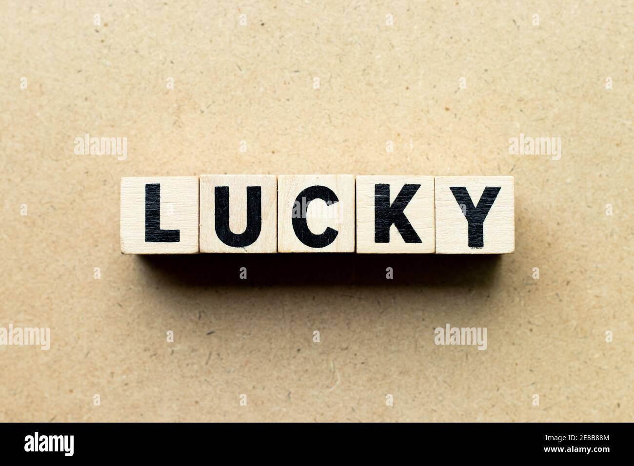 Letter block in word lucky on wood background Stock Photo - Alamy