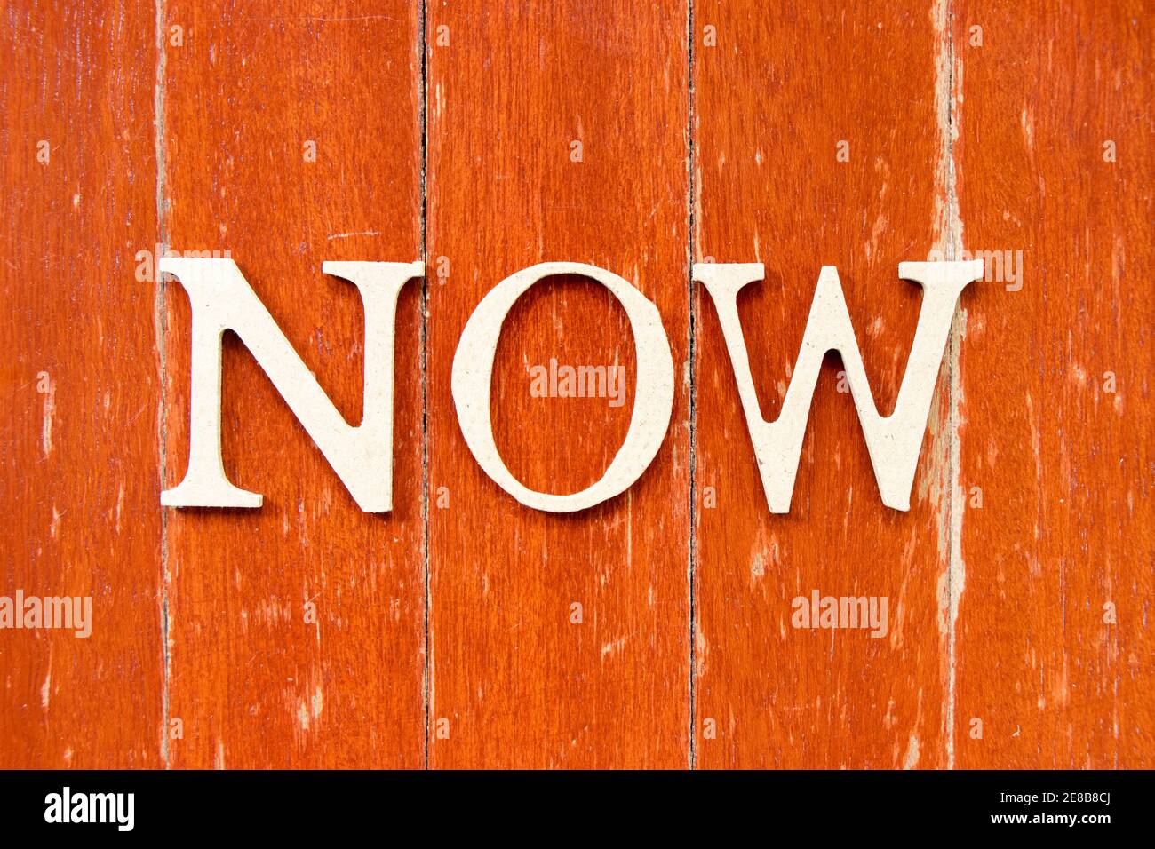 Alphabet letter in word now on old red color wood plate background ...