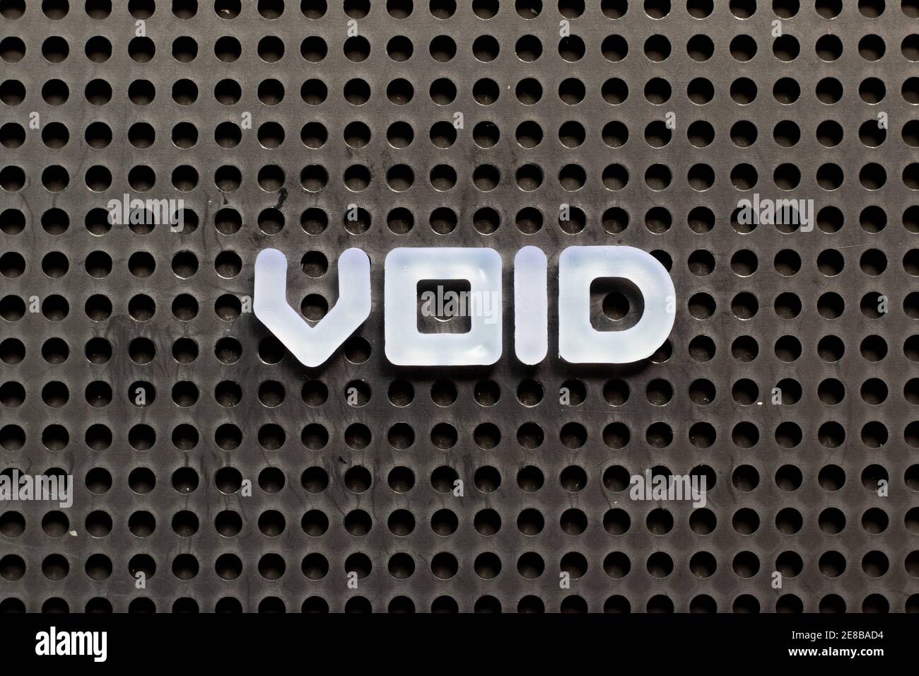 White color letter in word void on black pegboard background Stock ...