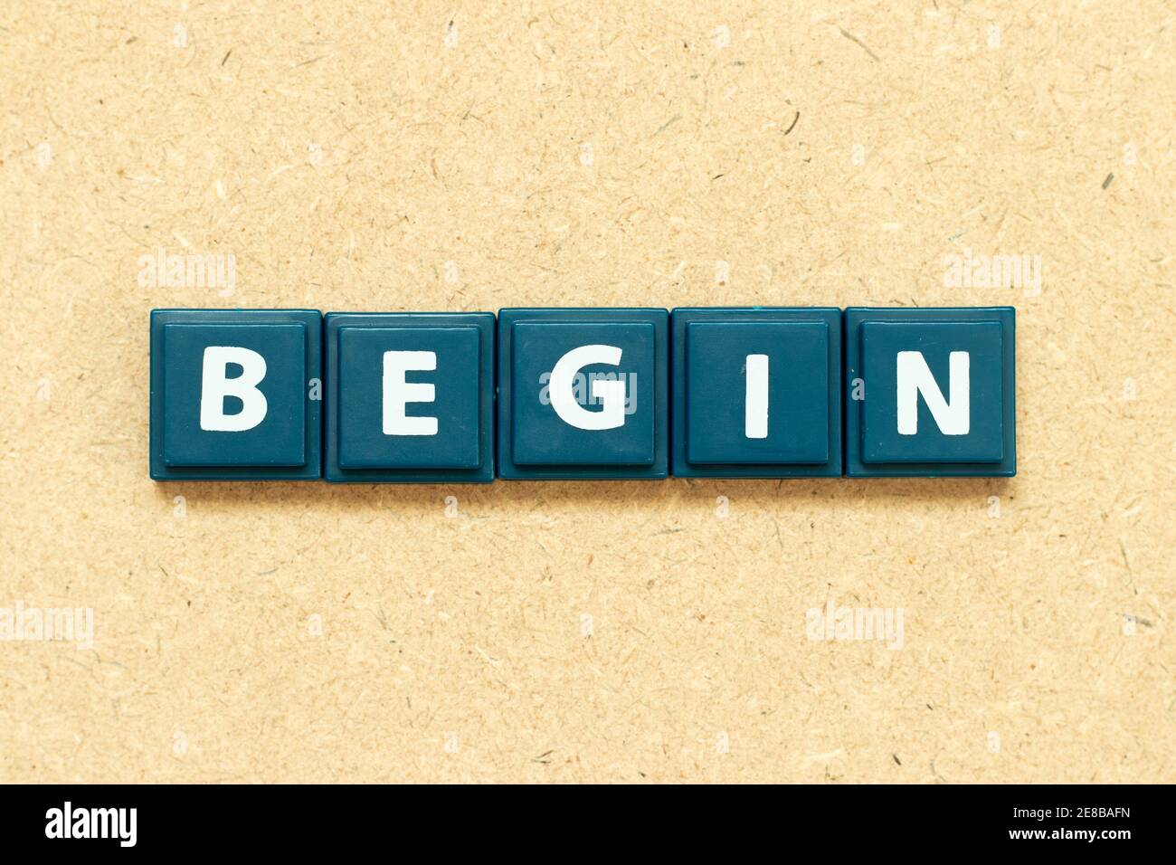 Tile alphabet letter in word begin on wood background Stock Photo - Alamy