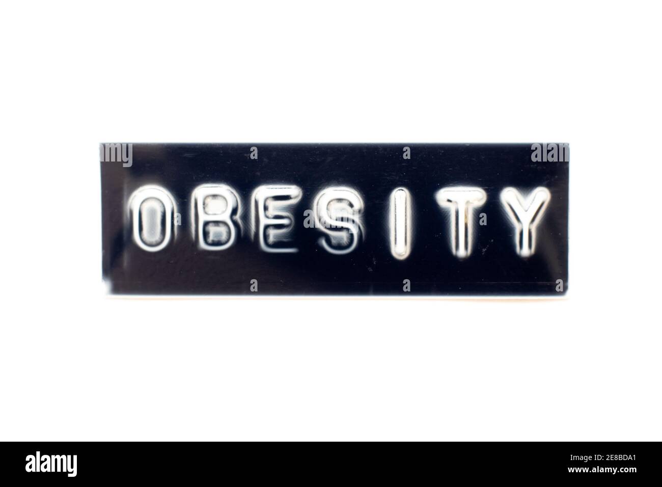Embossed letter in word obesity on black banner with white background ...