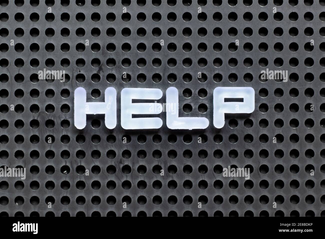 White color letter in word help on black pegboard background Stock ...